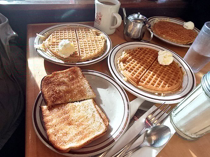 Waffles with perfect grid patterns that would make any engineer proud. The butter melts just right, like nature intended.