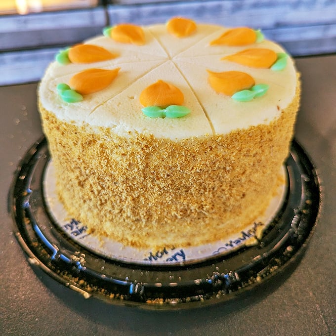 The carrot cake in its full glory—golden crumb coating the sides like delicious armor protecting the moist treasure within.