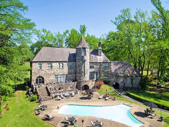 Bird's eye magic! From above, you can truly appreciate how this stone masterpiece nestles perfectly into its lush Arkansas surroundings.