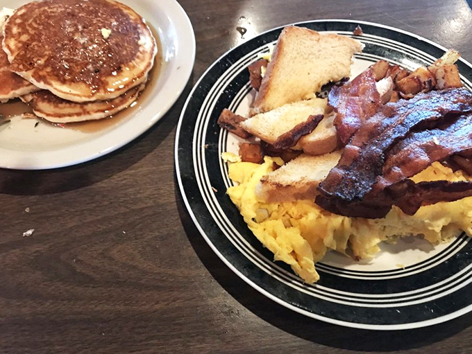 The holy trinity of breakfast: golden pancakes, scrambled eggs, and bacon cooked to that magical point between chewy and crisp. Morning salvation, served.