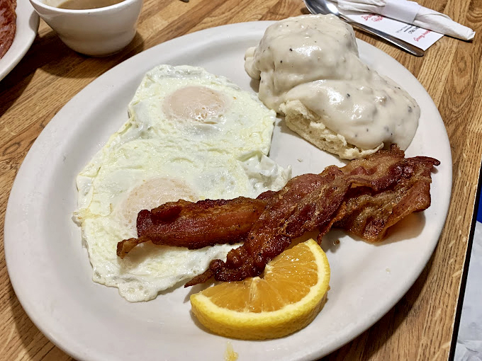 Eggs sunny-side up, bacon crisp enough to snap, and biscuits smothered in gravy &ndash; the holy trinity of Southern breakfast bliss.