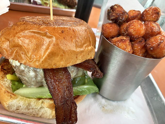 This bacon cheeseburger with sweet potato tots isn't just a meal&mdash;it's architecture. The bacon stands proudly like delicious flying buttresses.