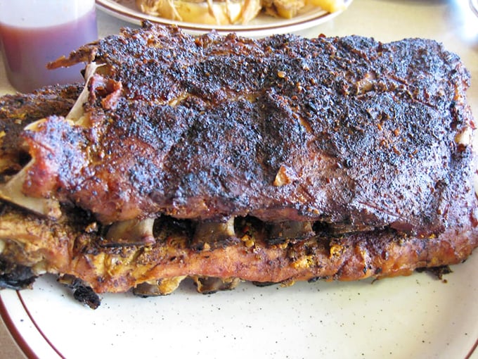 The holy trinity of barbecue perfection: slow-smoked meat, collard greens, and coleslaw that cuts through the richness like a well-timed joke.