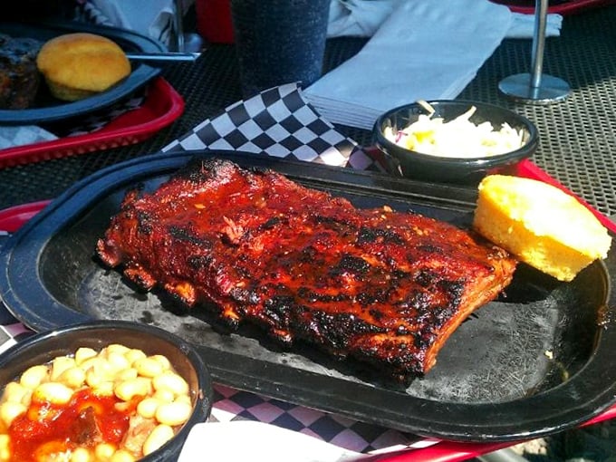 A half-rack of ribs that's worth the drive alone, flanked by golden cornbread and sides that refuse to be mere supporting characters.
