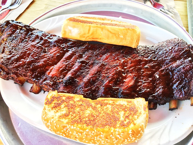 A half-slab of ribs flanked by Texas toast&mdash;the kind of plate that makes you consider whether napkins should be counted as a side dish.