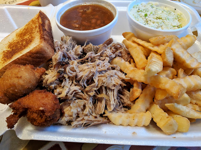 Southern hospitality on a plate: pulled pork, comfort sides, and that perfect hush puppy. Your diet called &ndash; it's taking the day off.