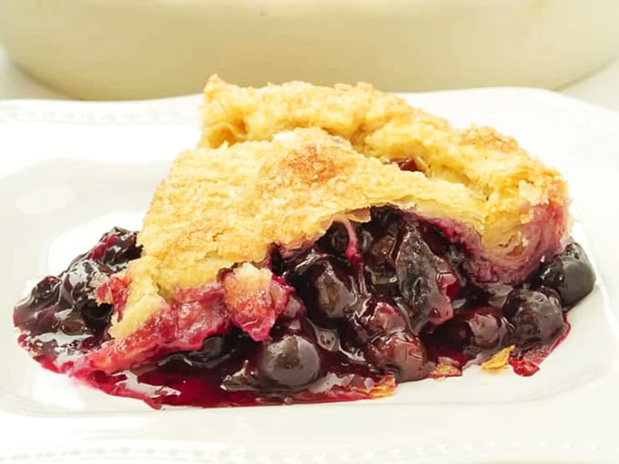 Berry pie that's worth every sticky-fingered bite. The perfect balance of sweet-tart filling and buttery crust creates a dessert worth traveling for.