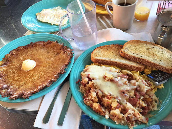 The holy trinity of breakfast: eggs cooked to sunshine perfection, toast with the ideal butter-to-bread ratio, and hash that deserves its own fan club.