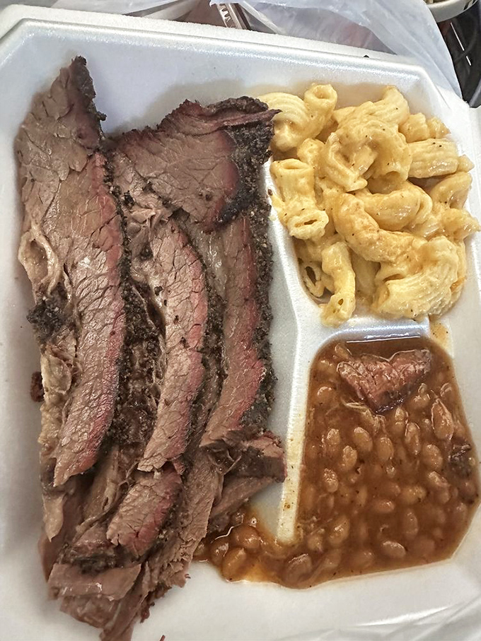 The holy trinity of barbecue perfection: sliced brisket with that telltale smoke ring, mac and cheese, and beans that didn't come from a can.