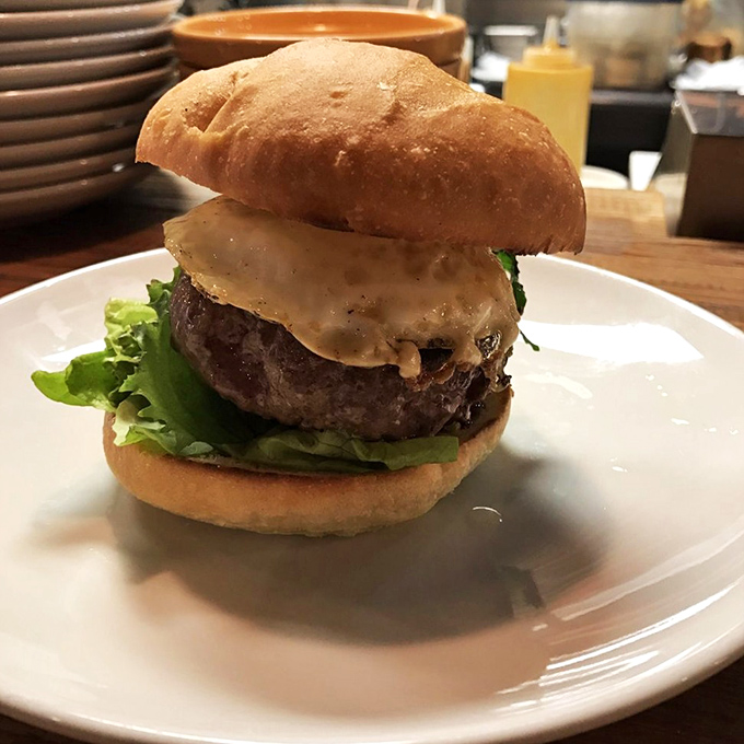 A burger that demands to be photographed, then immediately devoured. That melty cheese layer isn't just topping&mdash;it's a commitment to excellence. 