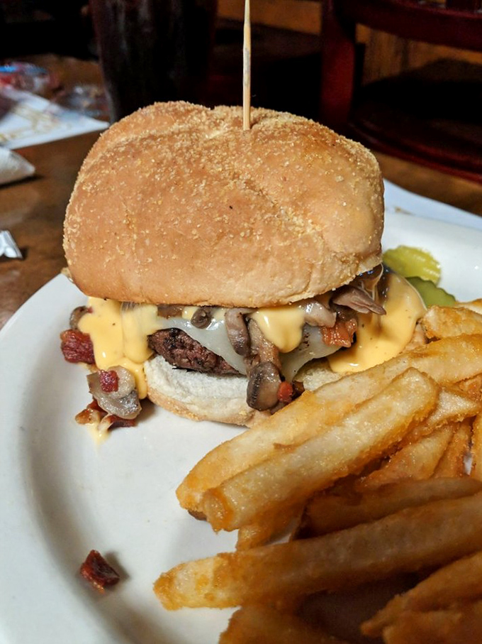 This isn't just a burger—it's an architectural marvel of beef, mushrooms, bacon and cheese that requires both hands and absolutely no dignity to consume.