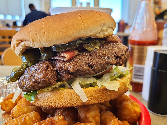 Behold the burger in its natural habitat: thick patty, fresh toppings, and a bun that knows its supporting role perfectly.