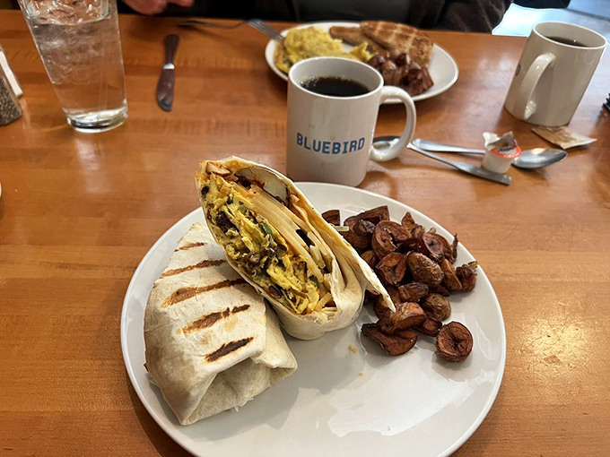 Breakfast burritos: where morning meets innovation. This handheld masterpiece pairs perfectly with The Bluebird's signature coffee and home fries.