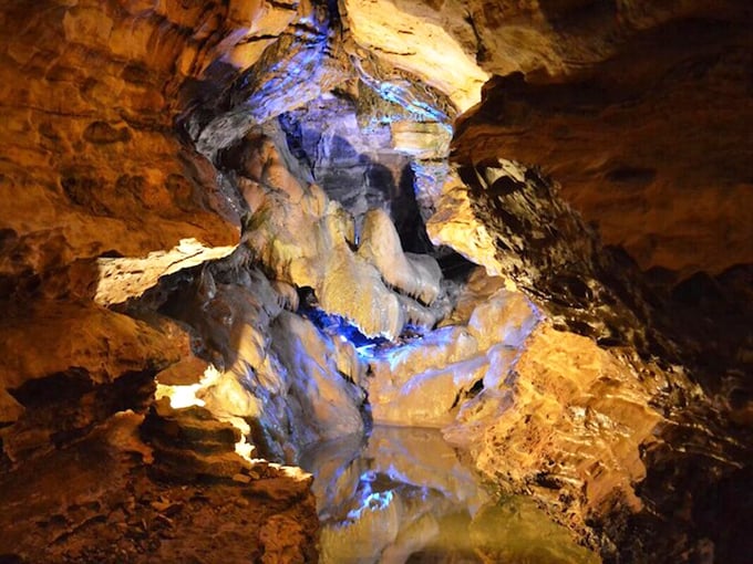 Inside Mark Twain Cave, limestone passages illuminate with an otherworldly glow, maintaining a perfect 52 degrees year-round&mdash;nature's original air conditioning.
