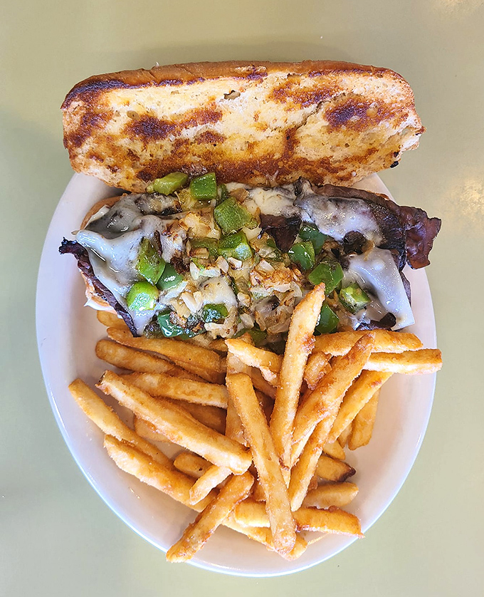 This isn't just a cheesesteak&mdash;it's a masterclass in melty perfection. Those fries look like they're auditioning for a supporting role award.