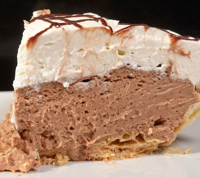 Chocolate mousse meets whipped cream in a flaky crust tango. This layered masterpiece makes chocolate lovers weak at the knees.