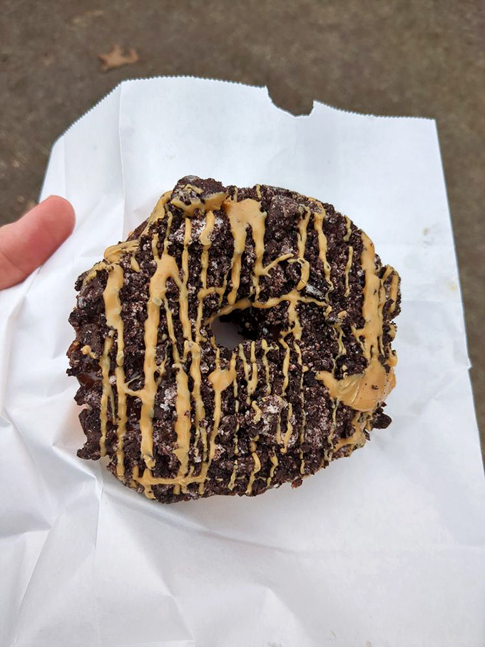 Not your average apple fritter. This glorious, cinnamon-speckled behemoth is what happens when bakers decide "reasonable portion size" is merely a suggestion.