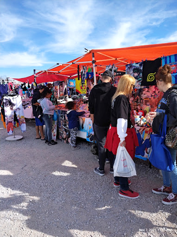 Anime enthusiasts browse under vibrant tents. The universal language of fandom brings shoppers together in this colorful marketplace.