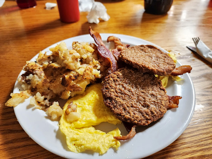 The breakfast trinity: perfectly scrambled eggs, crispy hash browns, and toast that knows its supporting role. Simple food done right.