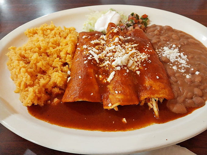 These enchiladas aren't just rolled tortillas&mdash;they're flavor torpedoes wrapped in corn, bathed in sauce that's been simmering since before your last birthday.
