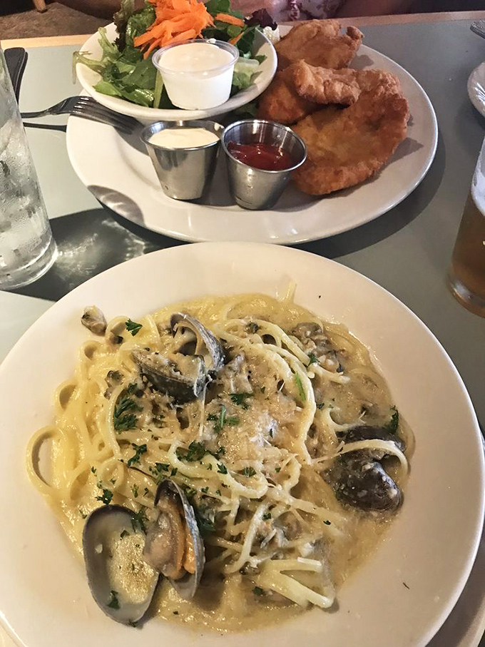 A pasta symphony of linguine with clams alongside golden fish and chips&mdash;proof that sometimes the best ocean views are right on your plate.