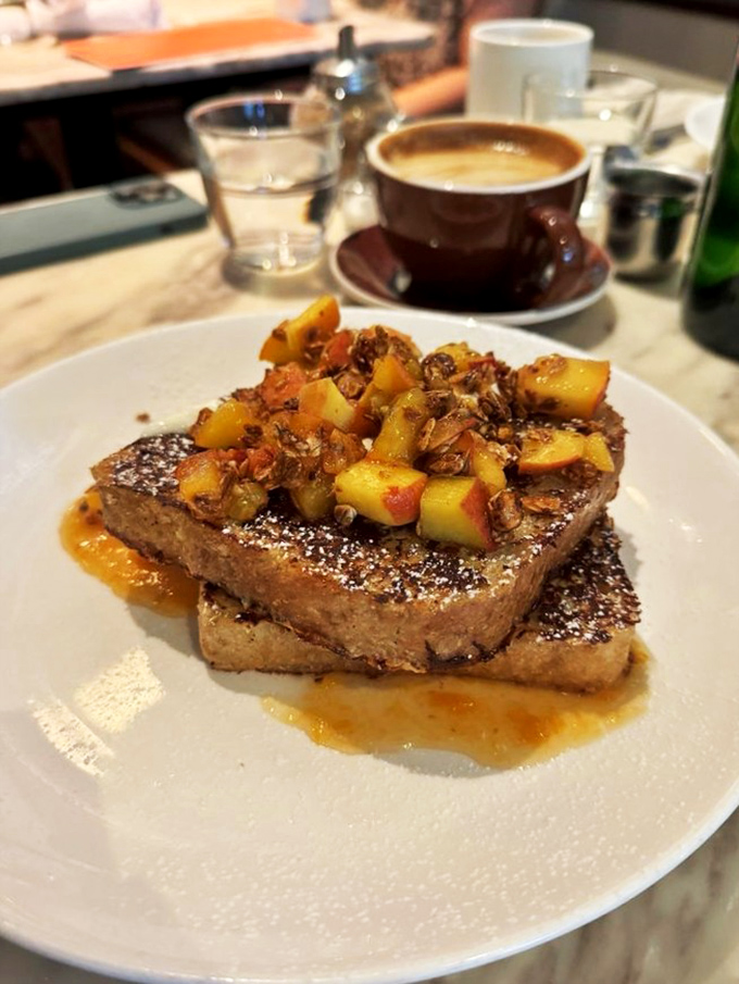French toast that makes you question all other French toast. Those caramelized fruit toppings and that dusting of powdered sugar? Pure morning poetry.