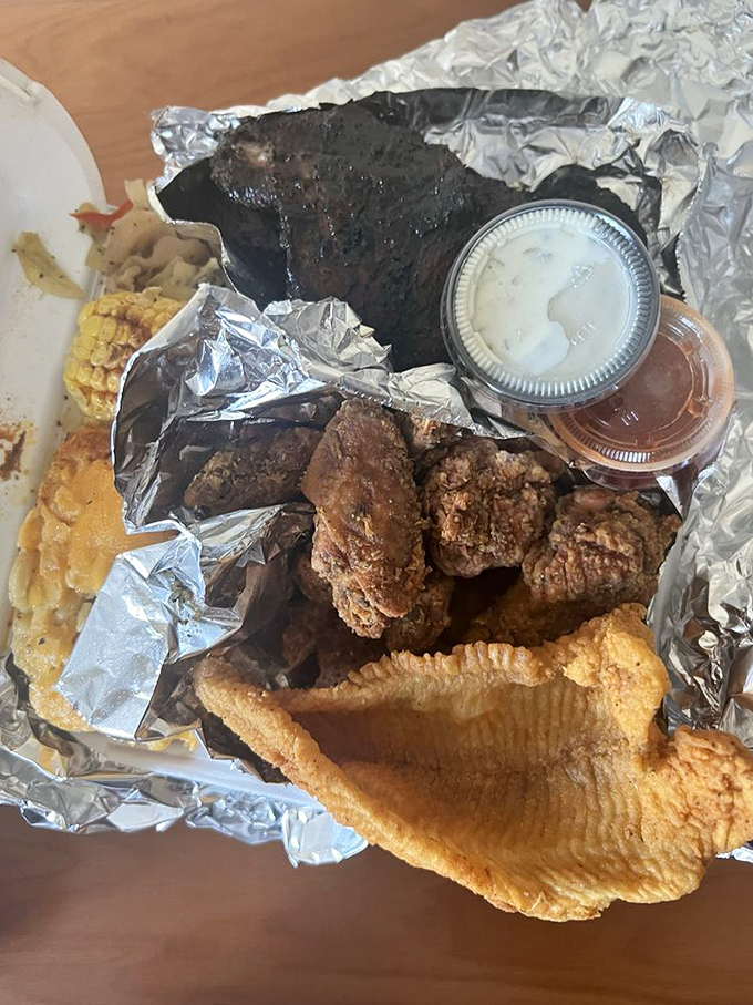 The holy trinity of comfort: fried chicken, catfish, and BBQ on one plate. Not a diet plate unless your diet is "joy."