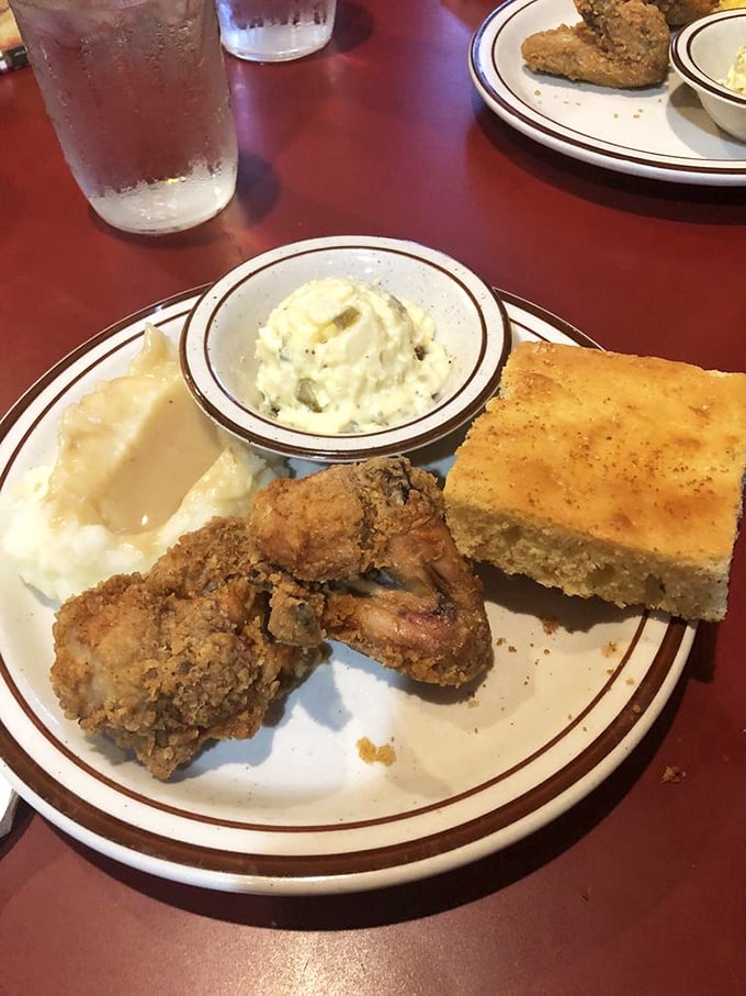 Southern harmony on a plate: crispy fried chicken, velvety mashed potatoes, and cornbread that demands to be savored.