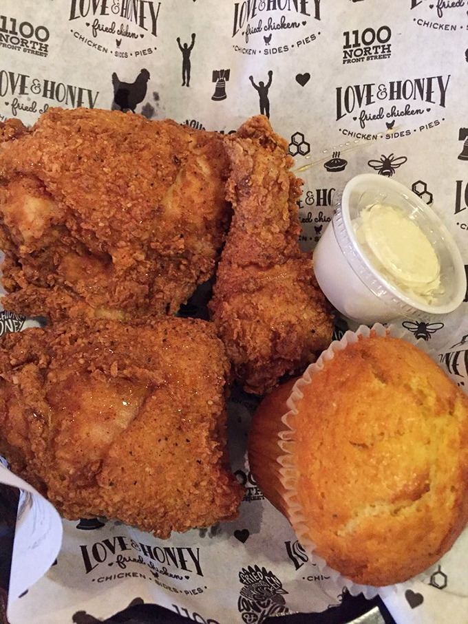 The holy trinity of Southern comfort: perfectly fried chicken, honey sauce, and a cornbread muffin that could make your grandma jealous.