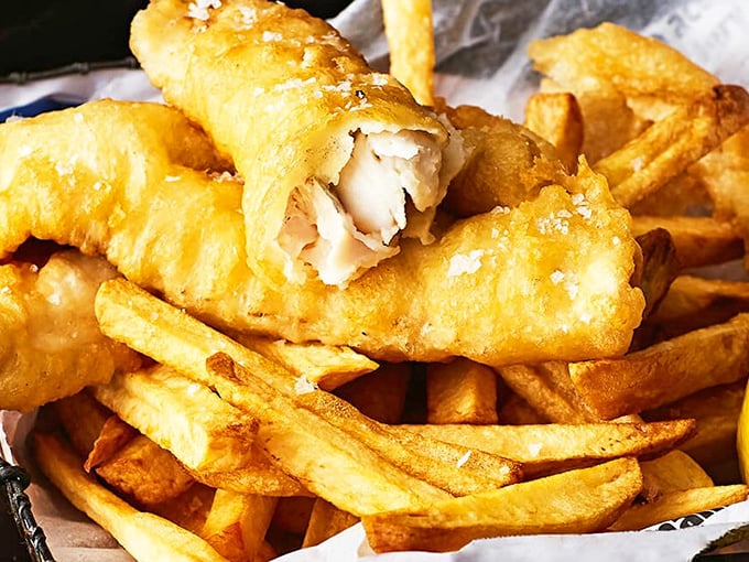 The money shot: tender white fish breaking apart to reveal moist flakes beneath a golden armor of crispy batter. Worth every calorie.