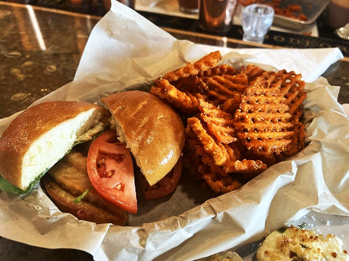 Sandwich nirvana served with a side of sweet potato waffle fries. This golden-fried grouper masterpiece makes inland dining feel like oceanfront luxury.