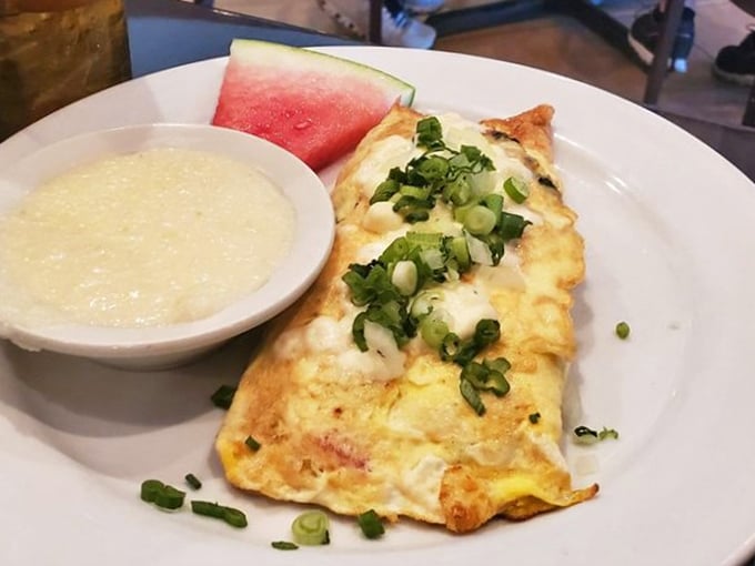 A perfect omelet with a side of grits and watermelon—proof that breakfast is the most important art form of the day.
