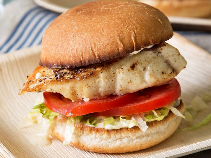 This isn't just a sandwich; it's architecture. Golden-crusted grouper balanced with fresh veggies on a pillowy bun &ndash; edible engineering at its finest.