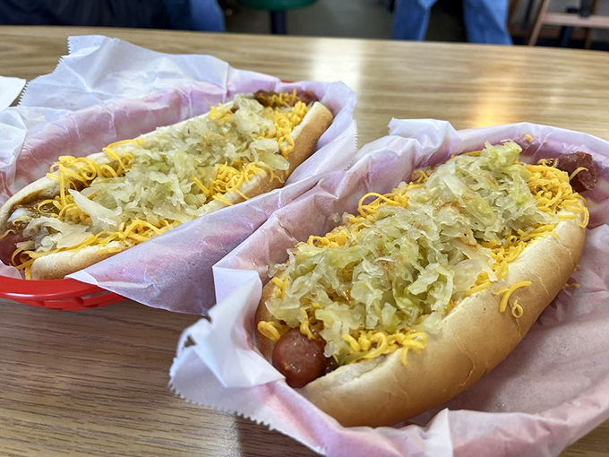 The kraut dogs arrive like twins separated at birth, reunited on your table. That sauerkraut-cheese combo is the buddy comedy your taste buds need.