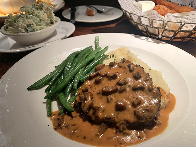 Behold the legendary meatloaf&mdash;nestled against bright green beans and creamy mashed potatoes, it's comfort food that graduated with honors.