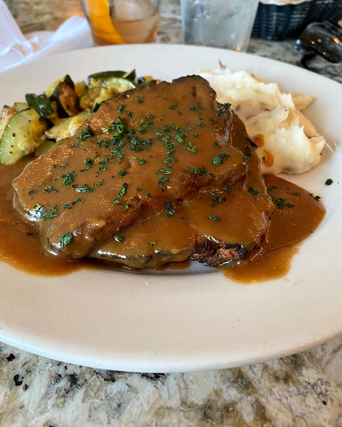 This isn't just meatloaf—it's a masterclass in comfort cuisine with perfectly roasted vegetables and gravy you'll want to swim in.