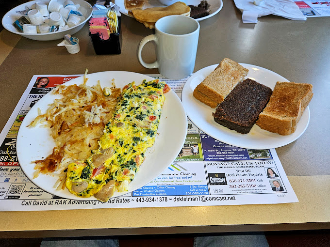 This isn't just an omelet&mdash;it's a technicolor dream of vegetables and cheese, with home fries that deserve their own fan club.