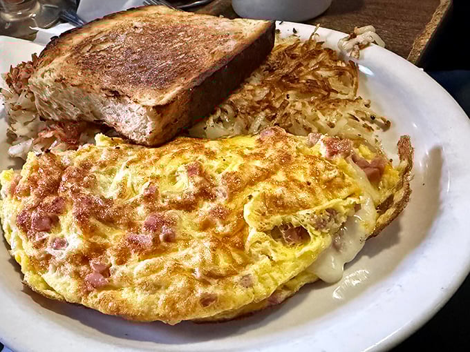 This ham and cheese omelet has achieved that golden-brown perfection that home cooks spend decades trying to master. Crispy edge nirvana!
