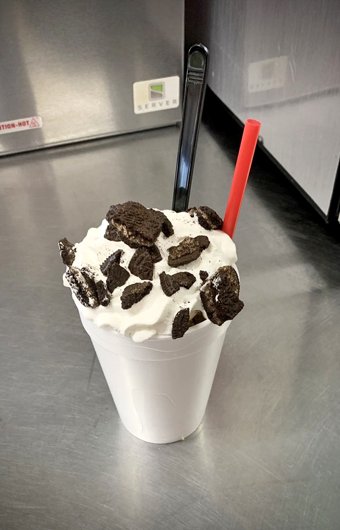 The Oreo milkshake stands tall like a monochromatic monument to childhood joy. Cookie chunks large enough to require dental insurance.
