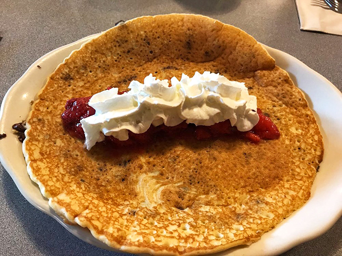 This pancake isn't just large&mdash;it's the size of your childhood dreams. The whipped cream and strawberry filling make it breakfast's answer to dessert.
