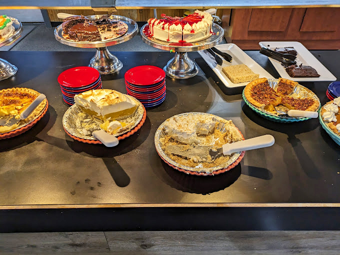 The dessert table—where diet plans go to die gloriously. These homestyle pies and cakes are worth every calorie-counting negotiation.