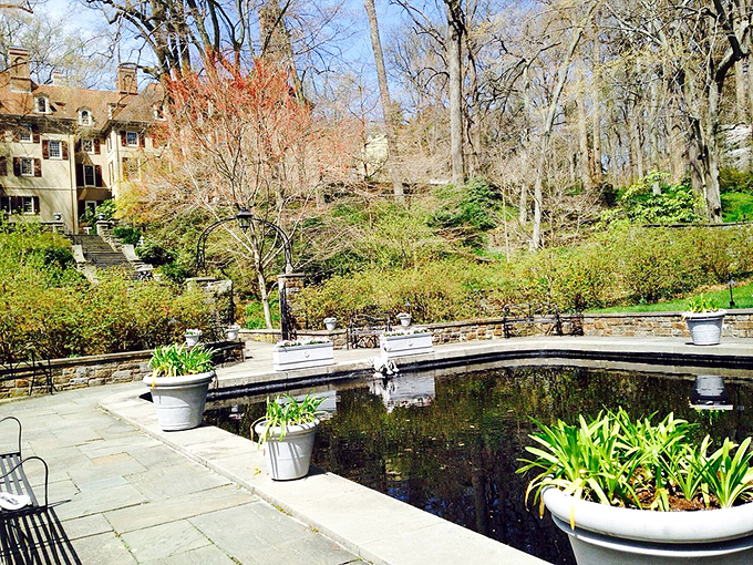 Serenity now! This reflecting pool creates the perfect mirror image of springtime's awakening, with planters standing sentry like well-dressed guardians of tranquility.