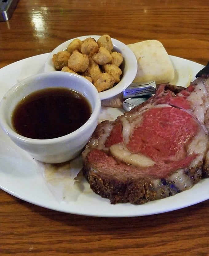 The Holy Trinity of comfort: perfectly pink prime rib, golden fried potatoes, and au jus deep enough to baptize each bite before it reaches heaven.