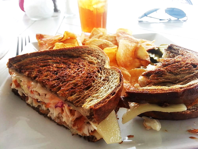 This Reuben transcends the ordinary with perfectly grilled marble rye creating that irresistible crunch that announces: serious sandwich ahead.