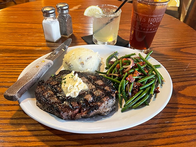 This ribeye doesn't just sit on the plate&mdash;it commands respect. The green beans with bacon are no mere side act.
