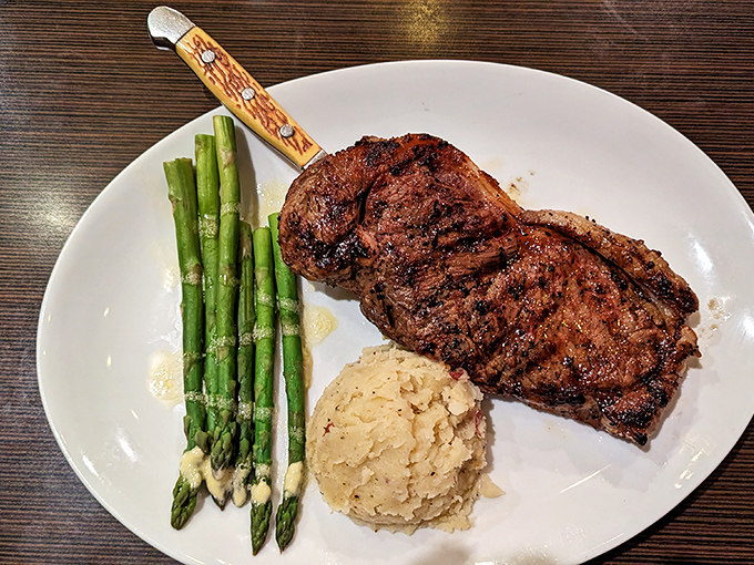 A perfectly charred ribeye with asparagus and mashed potatoes&mdash;the holy trinity of steakhouse perfection that never goes out of style.