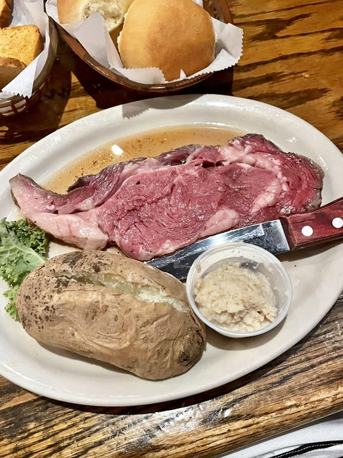 Heaven on a white plate: prime rib that's been slow-roasted to that magical point where it practically surrenders to your knife with a gentle sigh.