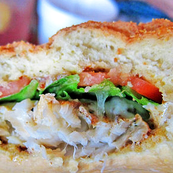 The moment of truth&mdash;flaky white fish peeking through a golden crust, with just enough fresh veggies to make you feel virtuous about your fried food choice.