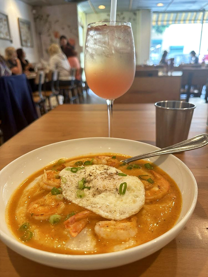 The holy trinity of brunch happiness: perfectly executed shrimp and grits, a refreshing cocktail, and zero plans for the rest of the day.