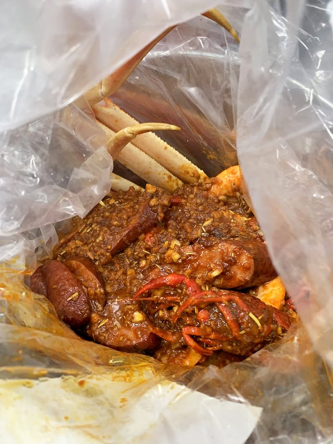 Peek inside the bag of treasures: snow crab, sausage, and potatoes swimming in cajun sauce. Like a pirate's chest, but edible.